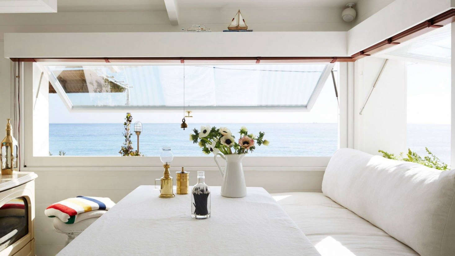 Seaside cabin filled with nautical space-saving tricks