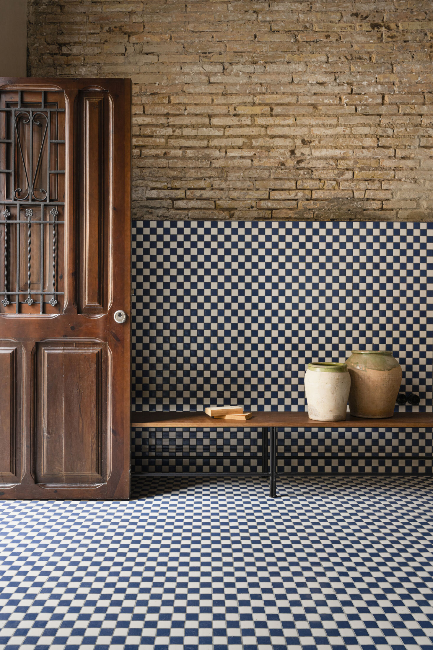 Checkerboard tile patterns a historic house remodel in Spain by Viruta Lab