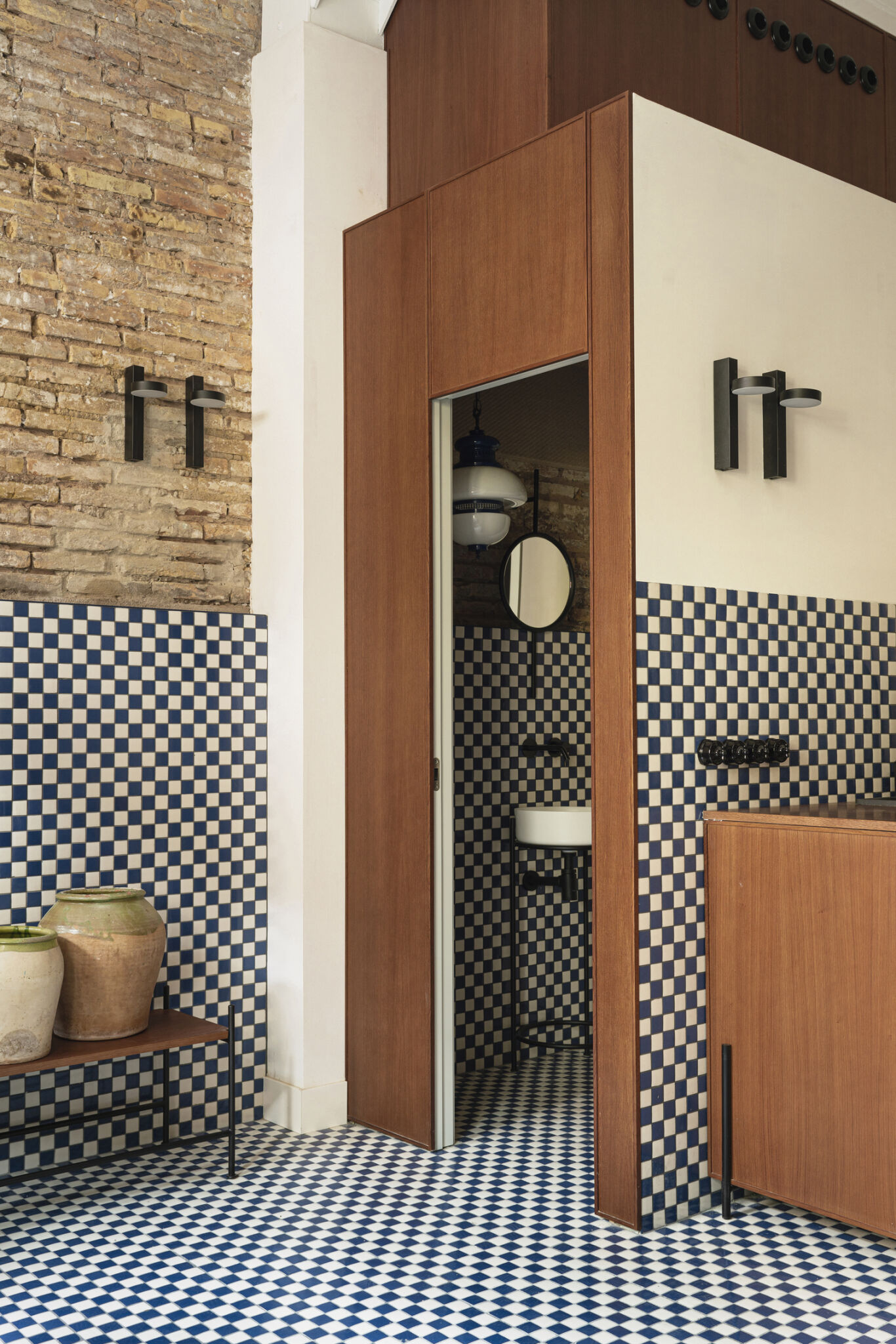 Checkerboard tile patterns a historic house remodel in Spain by Viruta Lab