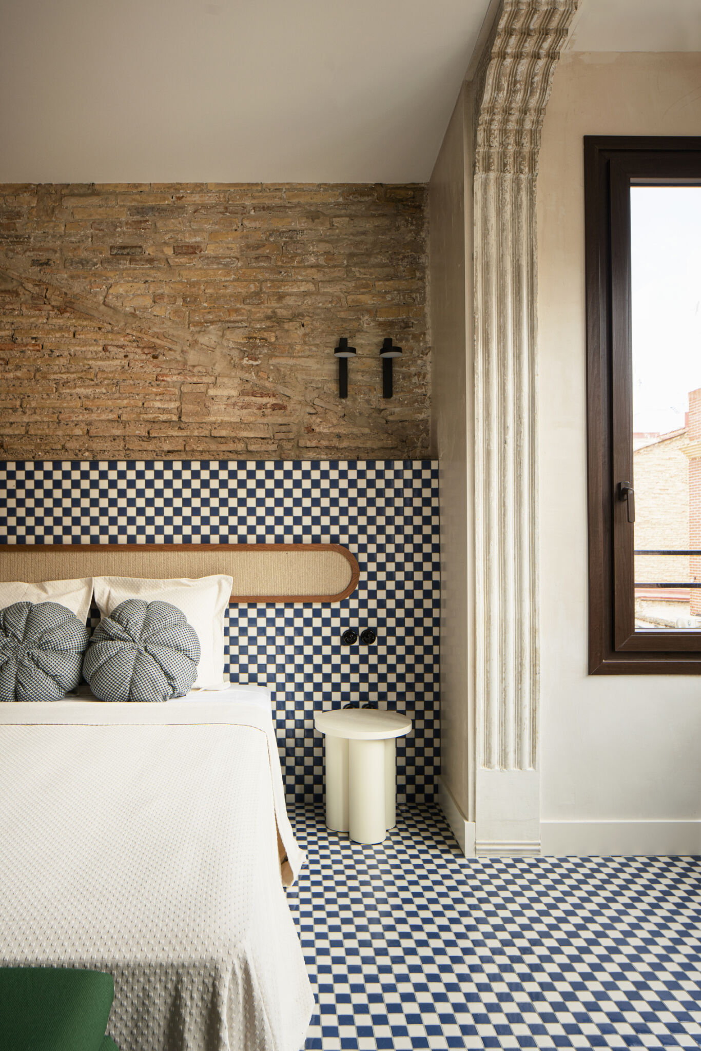 Checkerboard tile patterns a historic house remodel in Spain by Viruta Lab