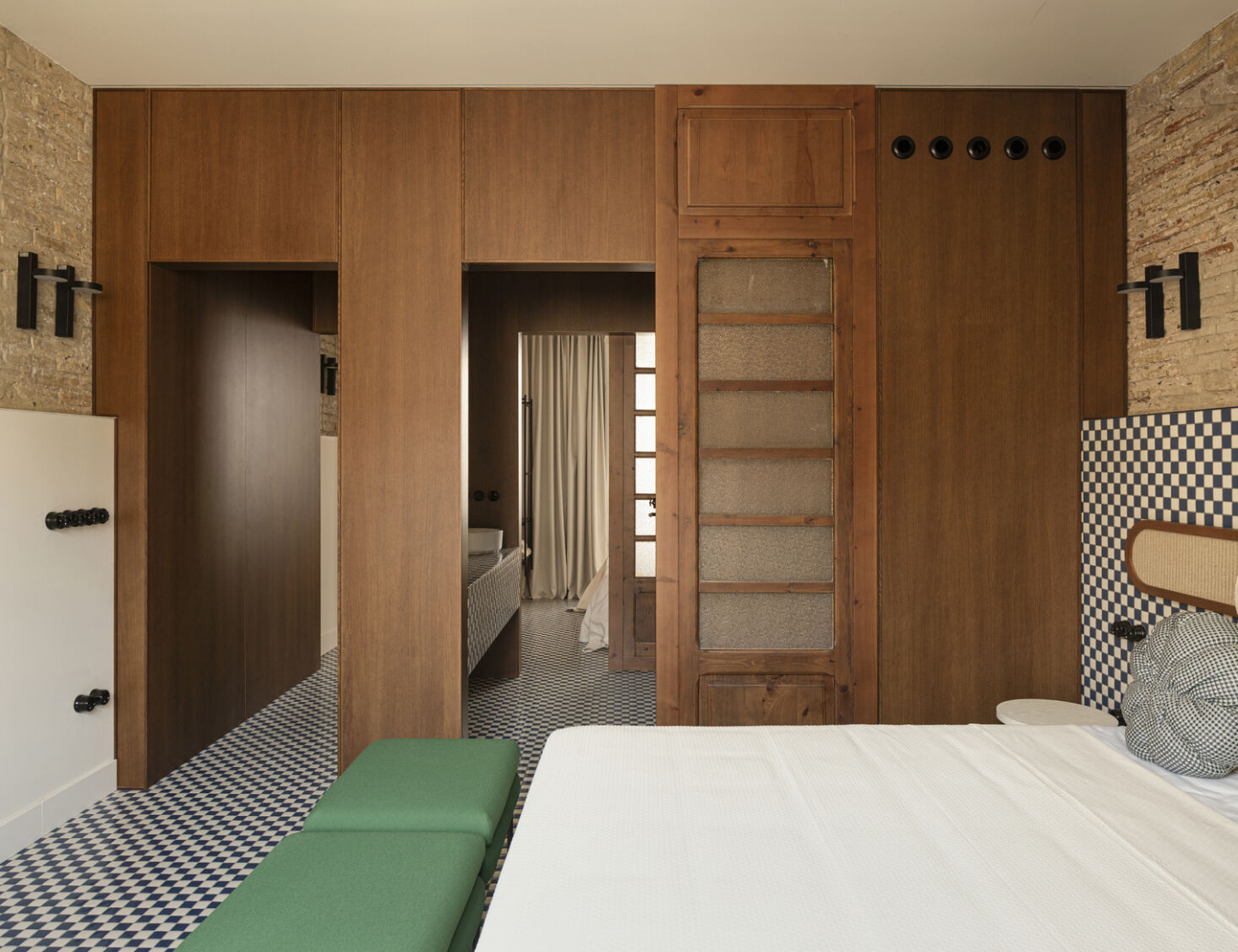 Checkerboard tile patterns a historic house remodel in Spain by Viruta Lab